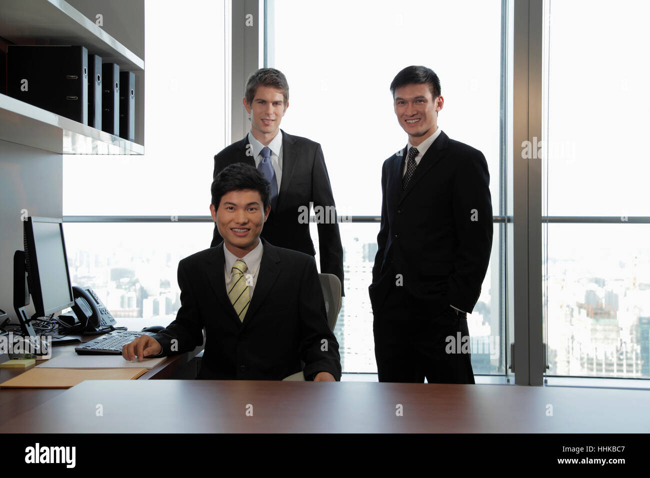 Three businessmen working together in an office Stock Photo - Alamy