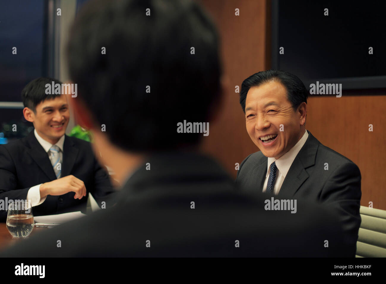 Businessmen laughing during a business meeting Stock Photo - Alamy