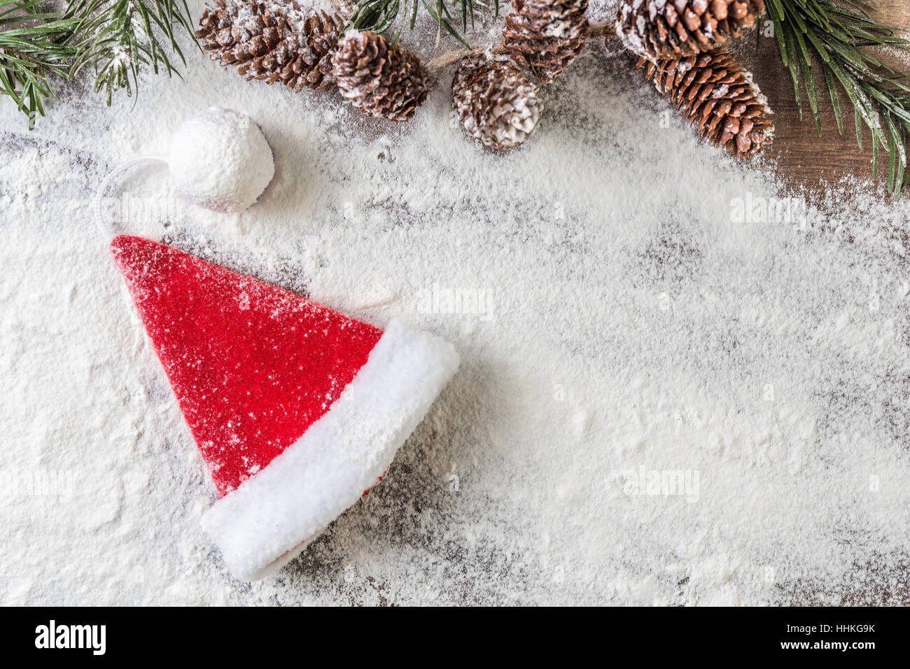 Santa Claus hat with snowy pine cones on a snow background Stock Photo ...
