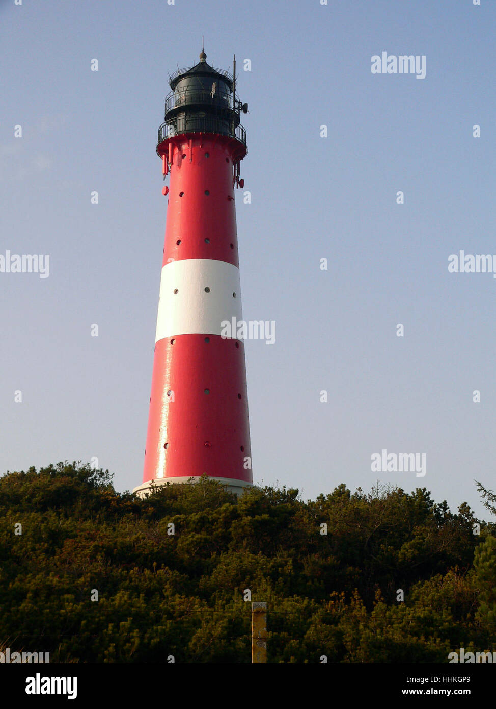 a red and white lighthouse in Northern Germany at evening time Stock ...