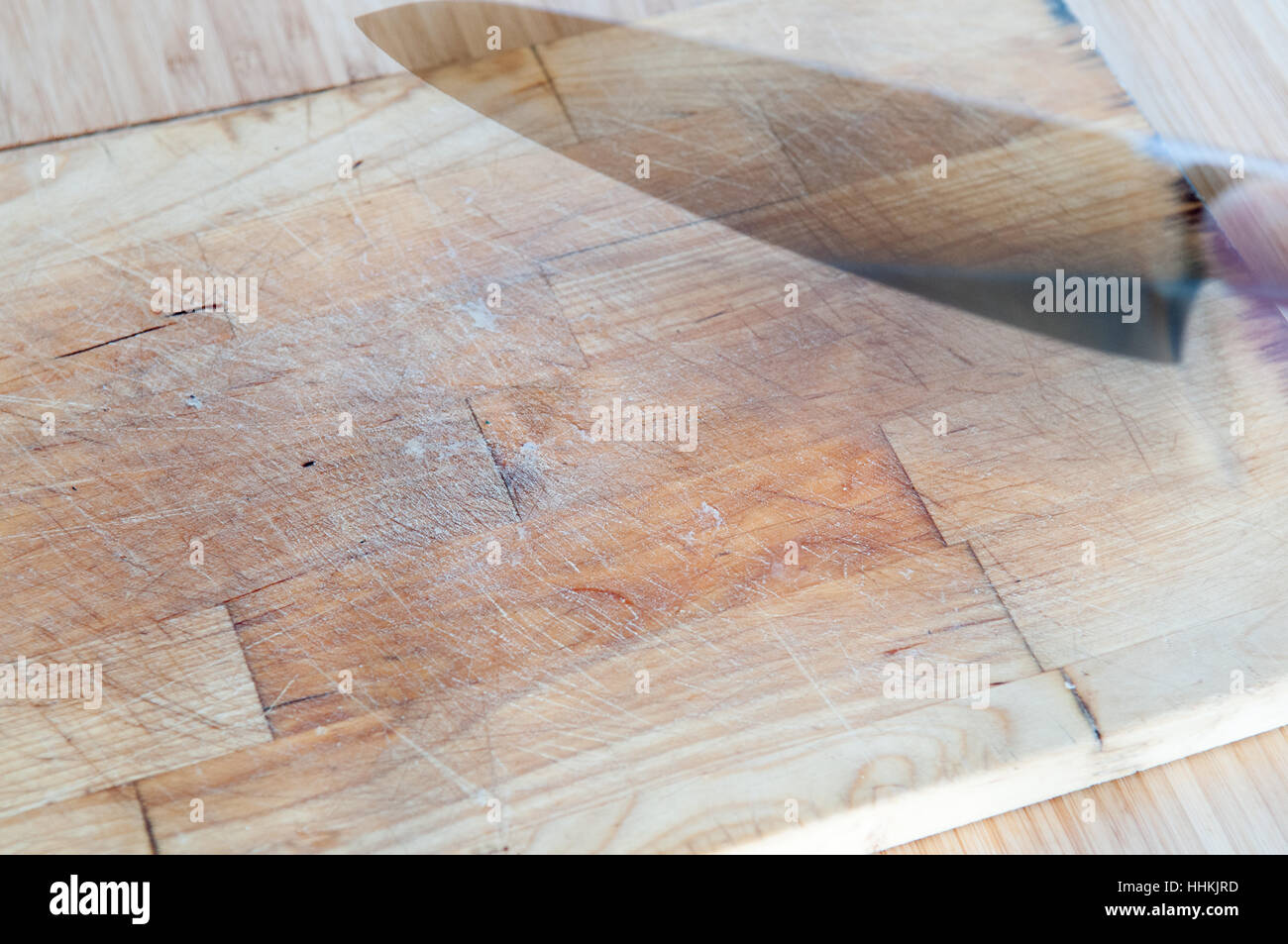empty chopping board for food preparation with moving knife Stock Photo ...
