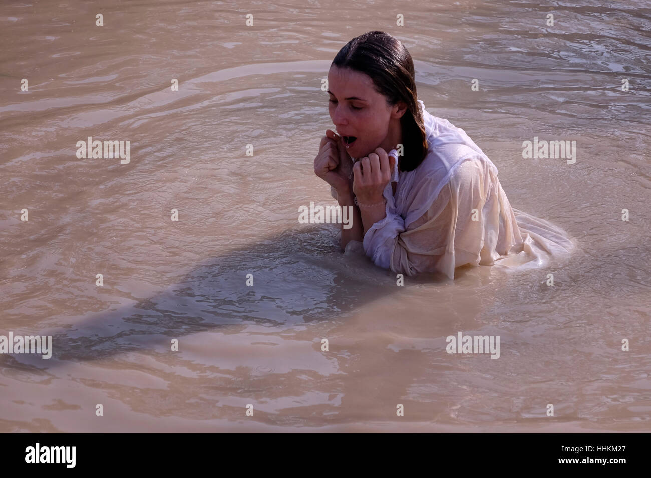 An Eastern Orthodox Christian pilgrim immersing herself in the water at ...
