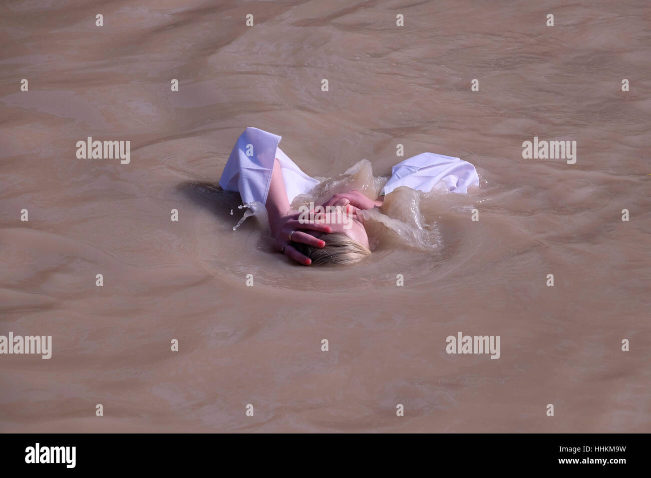 An Eastern Orthodox Christian pilgrim immersing herself in the water at ...