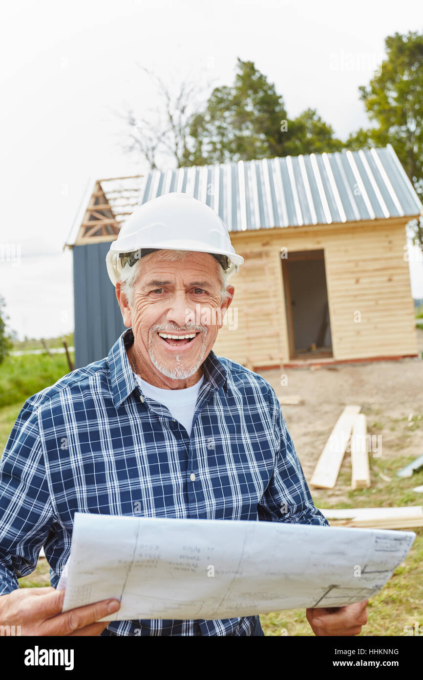 Smiling senior citizen as craftsman at construction site Stock Photo ...