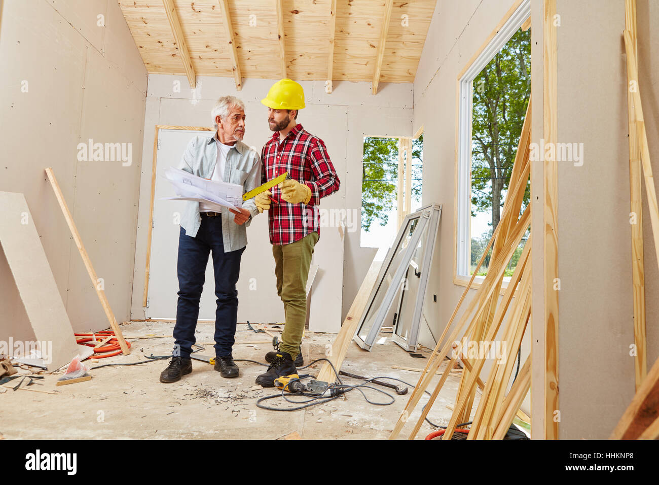 Architect and foreman working during meeting for building construction ...