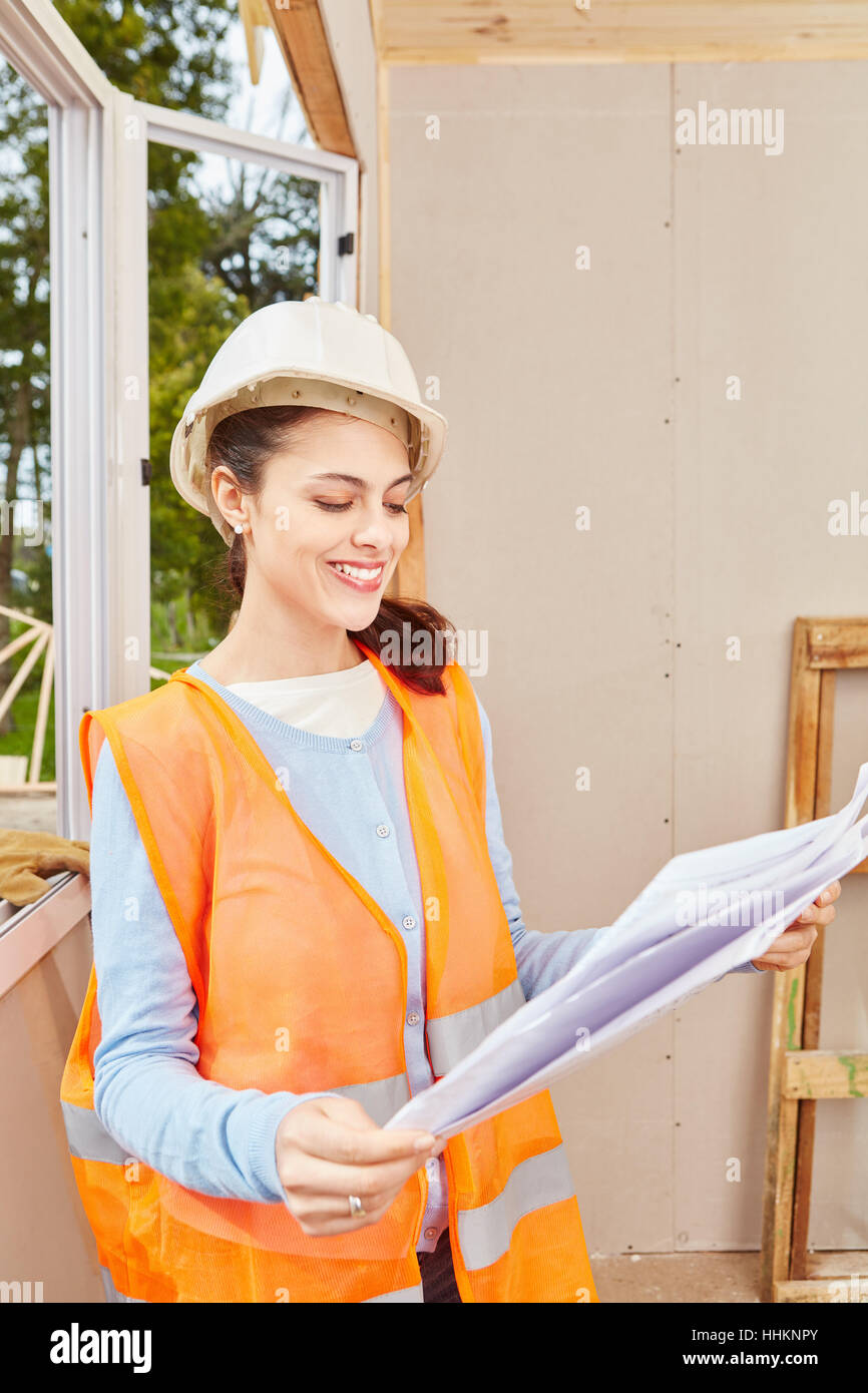 Woman as apprentice of craftsman holding architectural drawing Stock ...