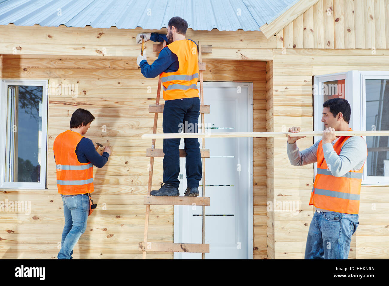 Team of carpenters working on new woodhouse Stock Photo - Alamy