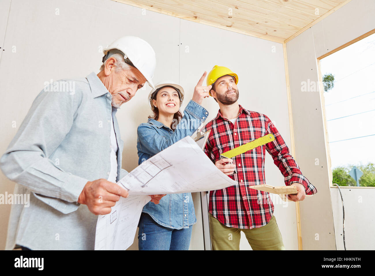 Architects planning new building construction with architectural ...