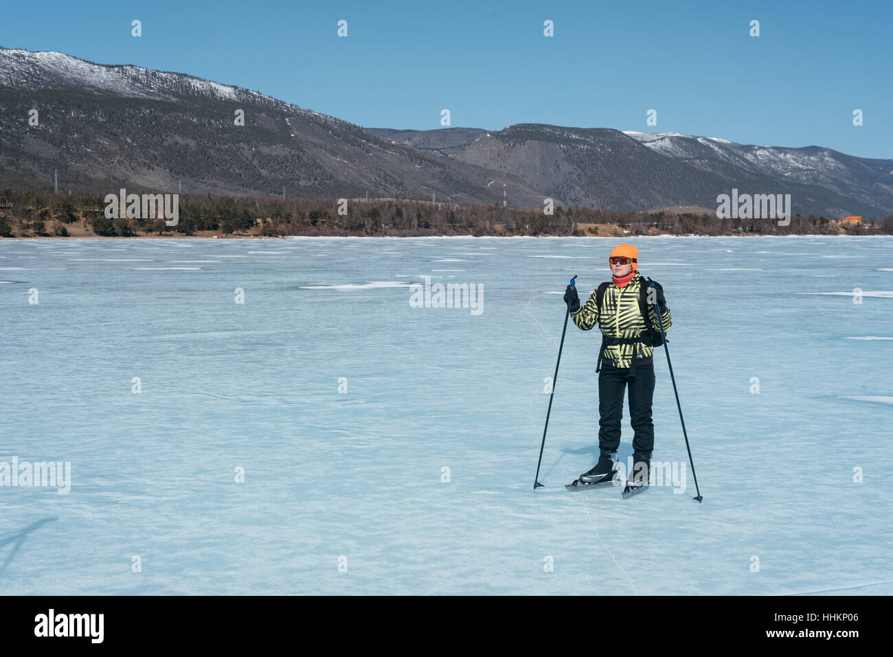 Tourists travel to Norway hiking ice skating on the frozen lake ...