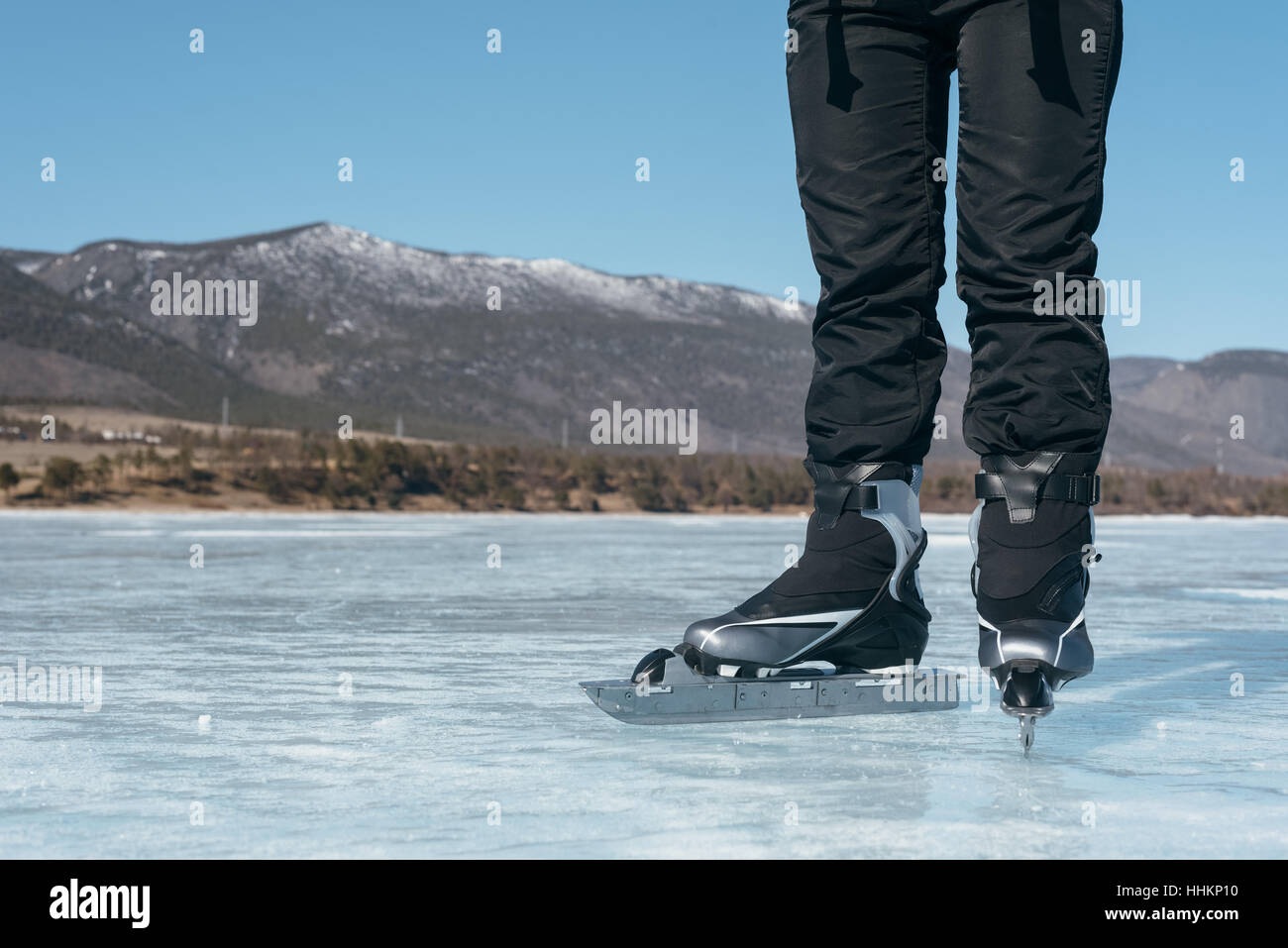 Tourists travel to Norway hiking ice skating on the frozen lake ...
