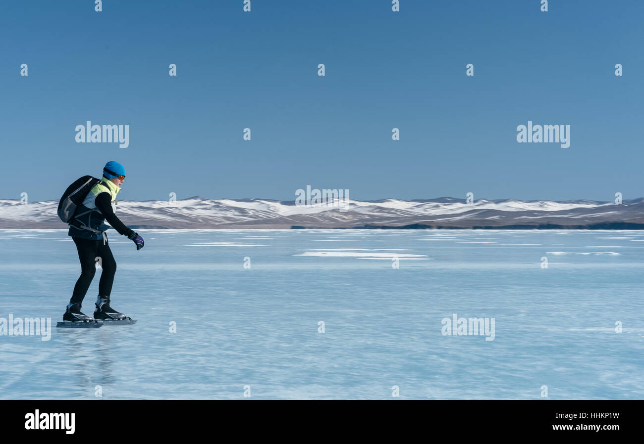 Tourists travel to Norway hiking ice skating on the frozen lake ...