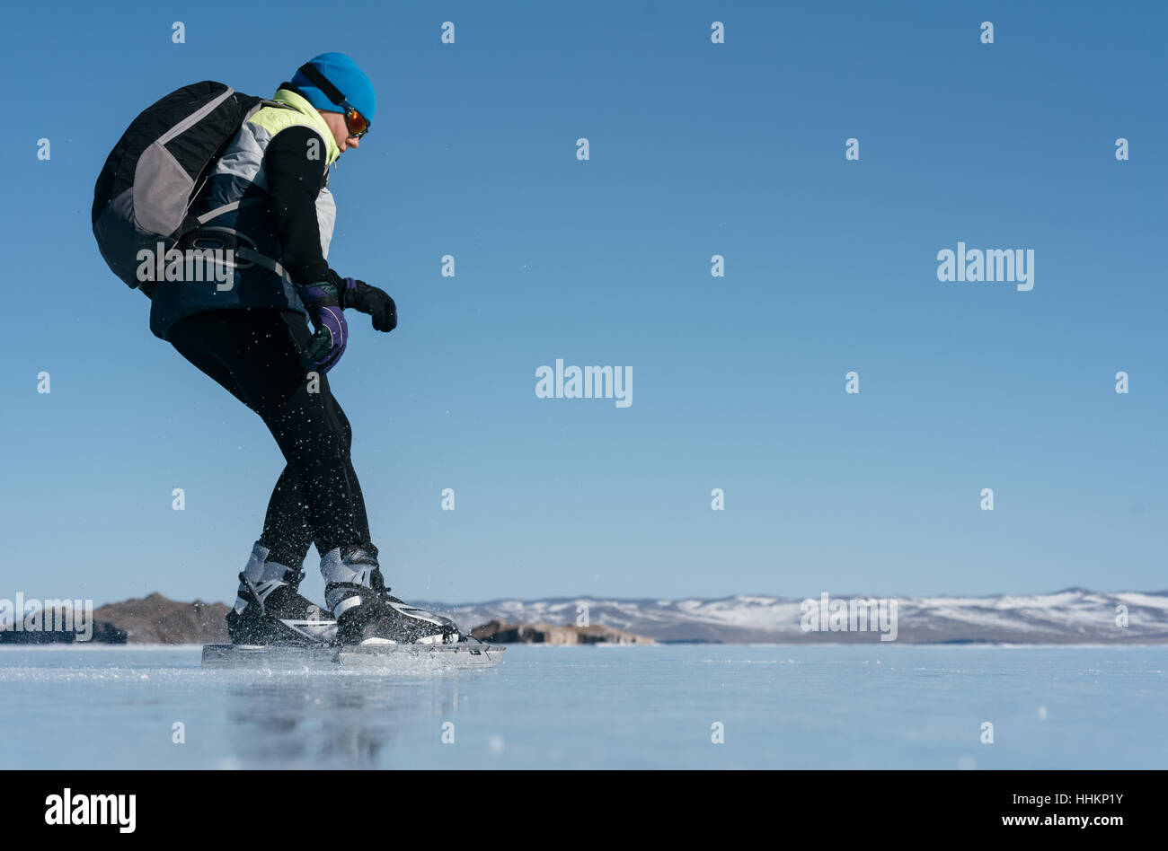 Tourists travel to Norway hiking ice skating on the frozen lake ...