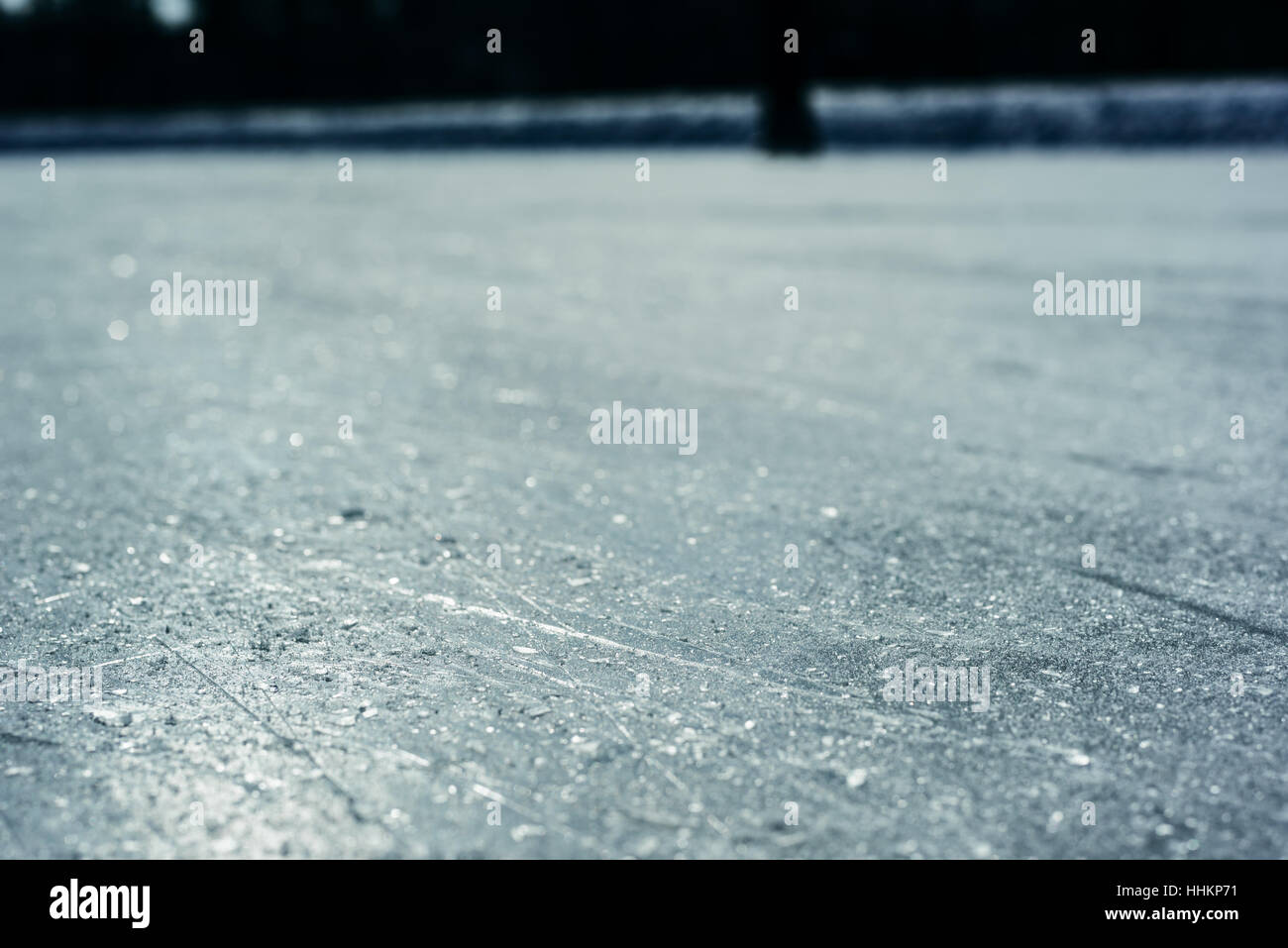 Bad ice at the city rink . many bands, cuts, cracks Stock Photo - Alamy