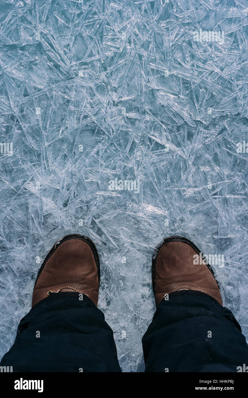 Legs traveler in shoes standing on thin ice and a beautiful ice Stock ...