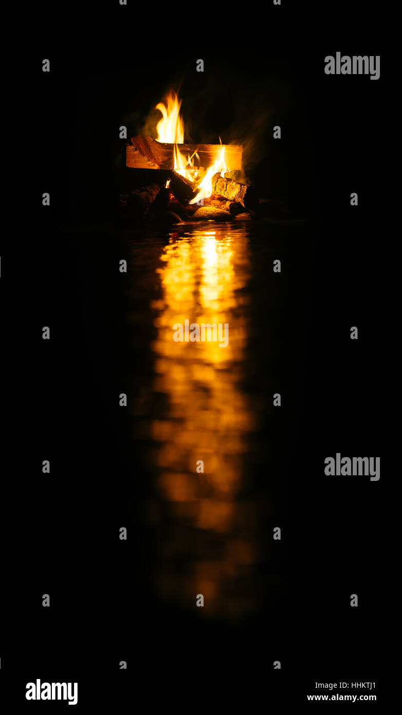 magic fire in the mountain river on the rocks at night. photo framed ...