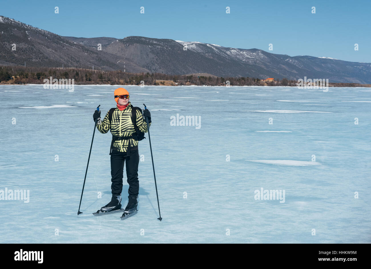 Tourists travel to Norway hiking ice skating on the frozen lake ...