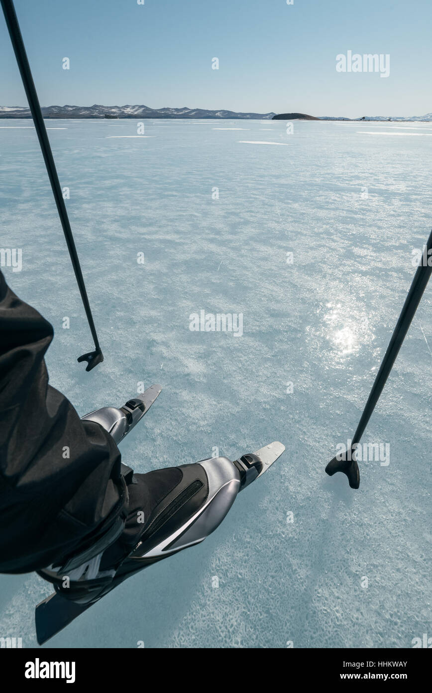 Tourists travel to Norway hiking ice skating on the frozen lake ...