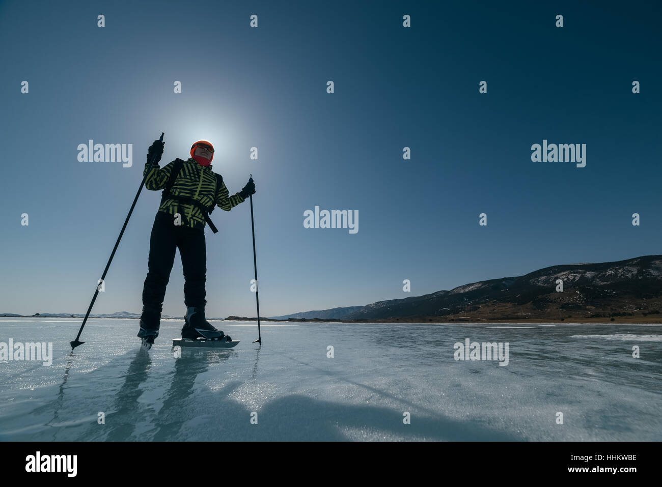 Tourists travel to Norway hiking ice skating on the frozen lake ...