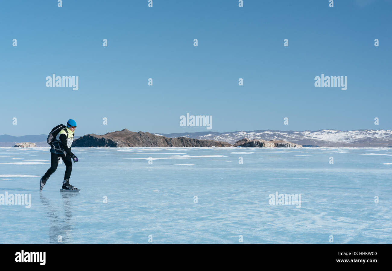 Tourists travel to Norway hiking ice skating on the frozen lake ...