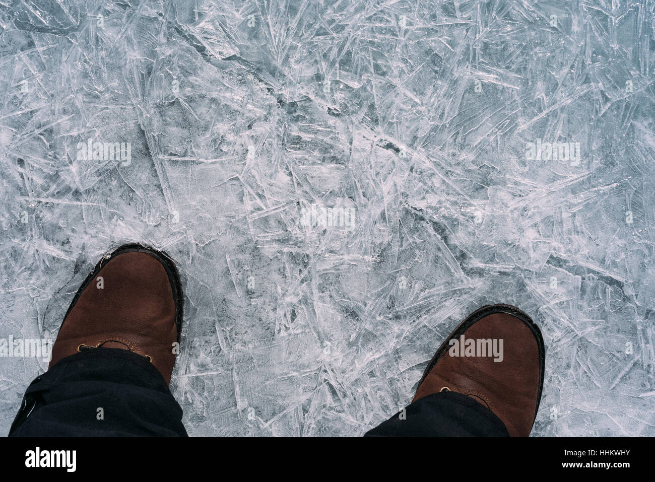 Legs traveler in shoes standing on thin ice and a beautiful ice Stock ...