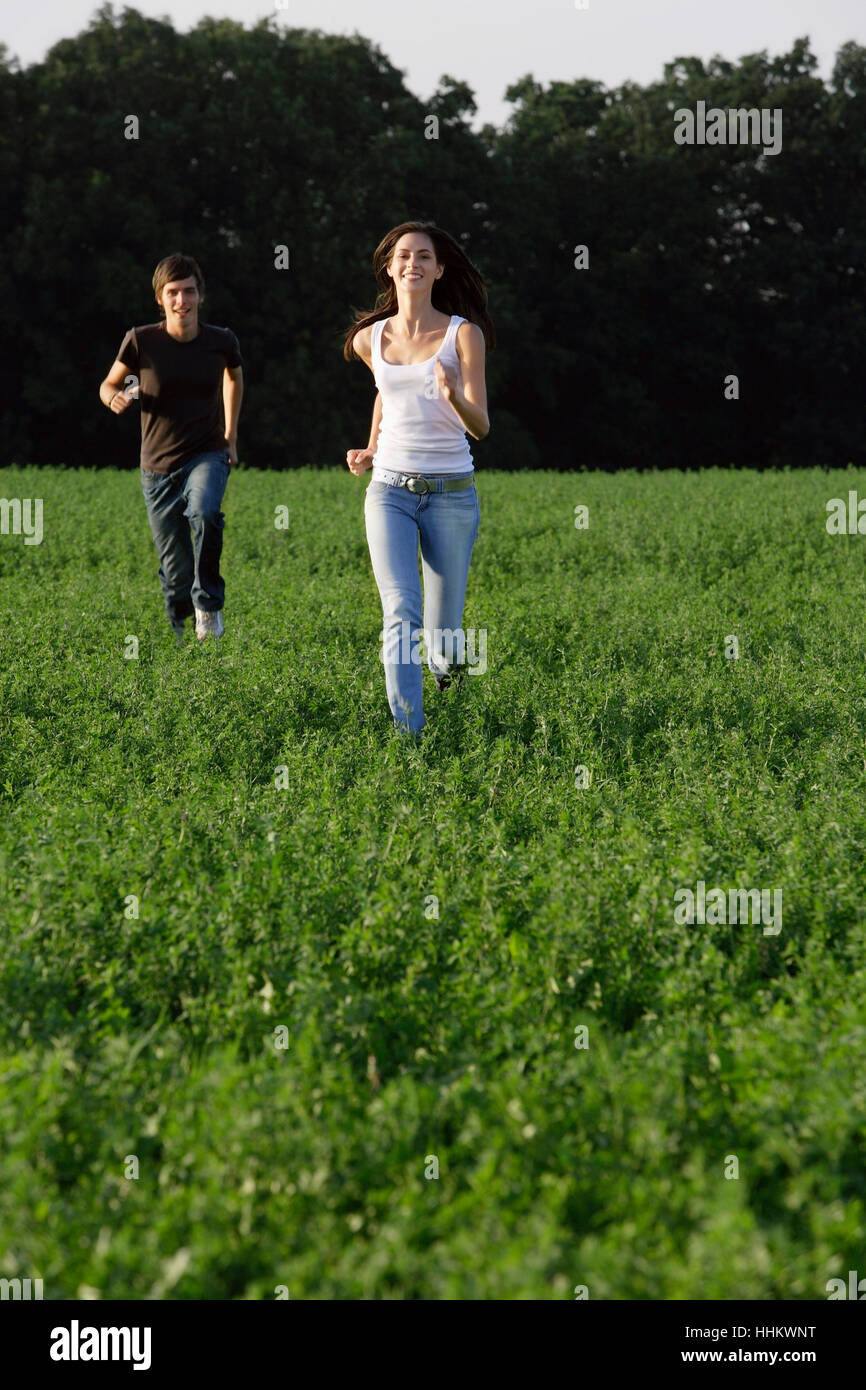 Young couple running in field Stock Photo - Alamy