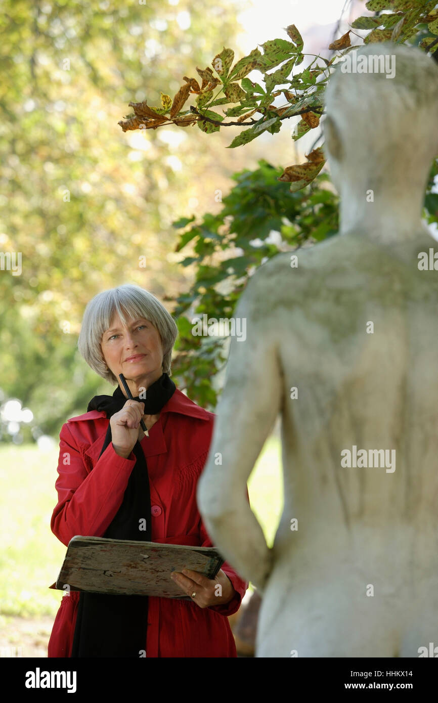 Senior woman pondering statue Stock Photo - Alamy