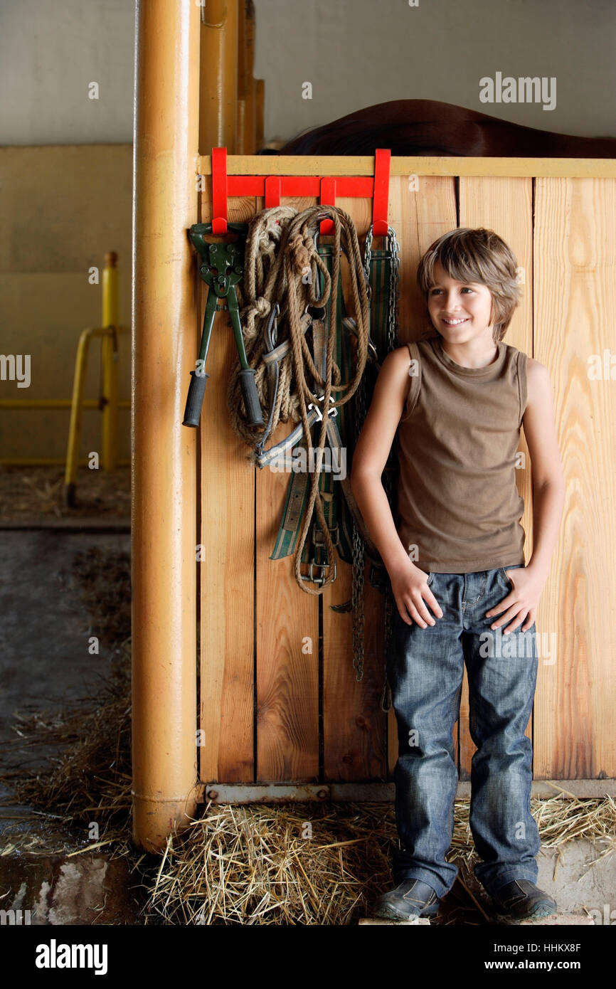 boy in stable next to horse Stock Photo - Alamy