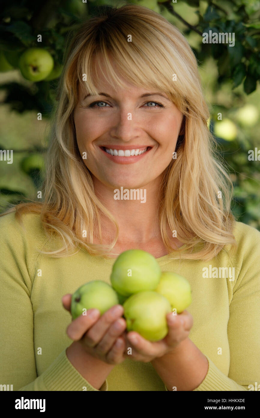 woman with apples under apple tree Stock Photo - Alamy