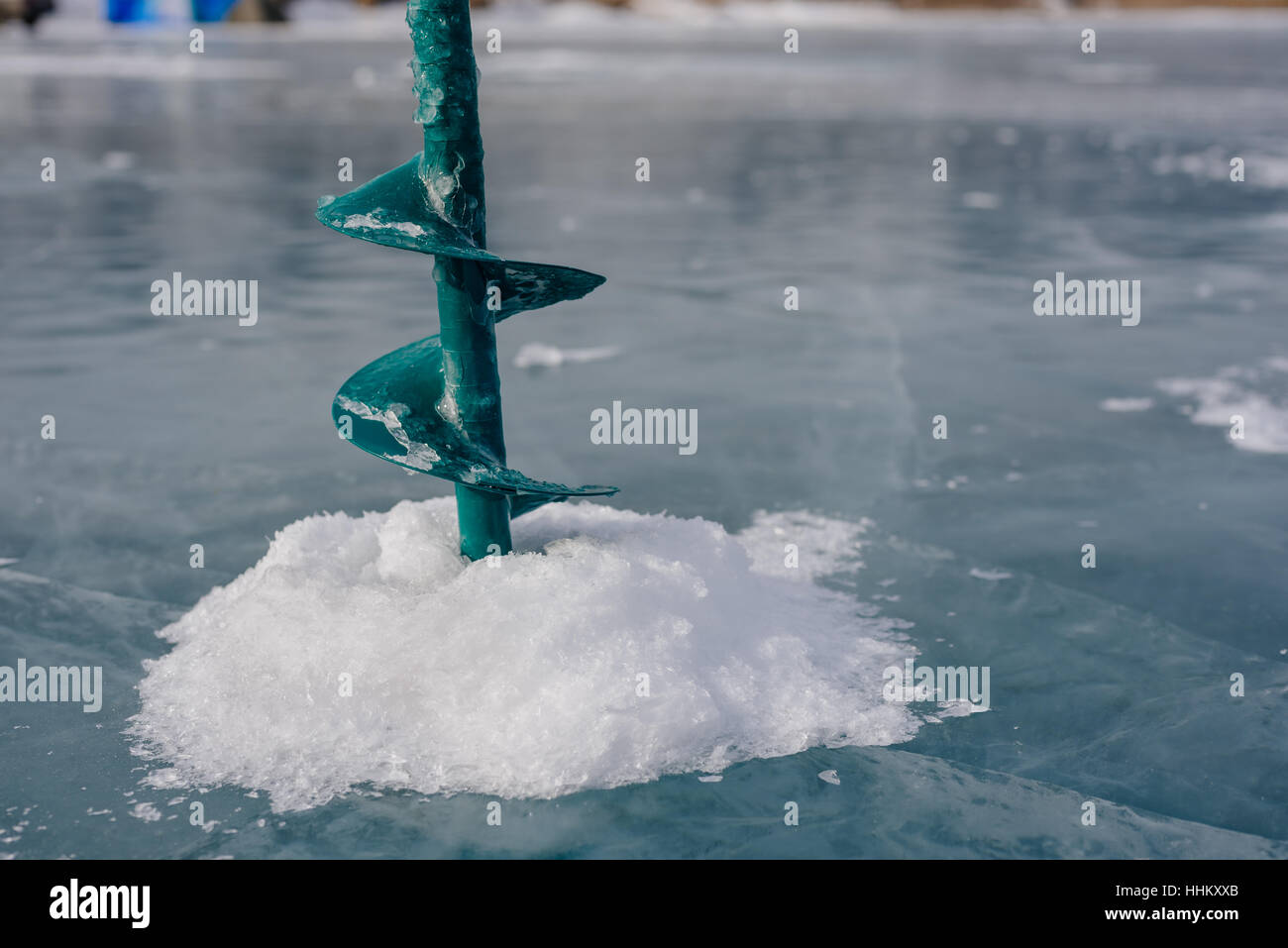 Ice ax - ice screws on winter fishing on the ice caves. Ice is very ...