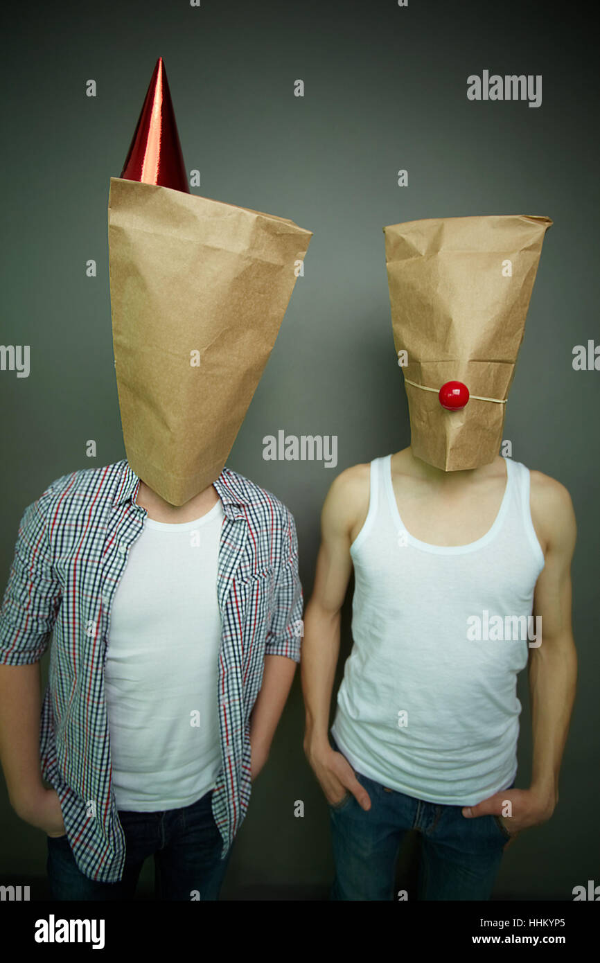 Two guys standing in front of camera in paper bags celebrating fool’s ...