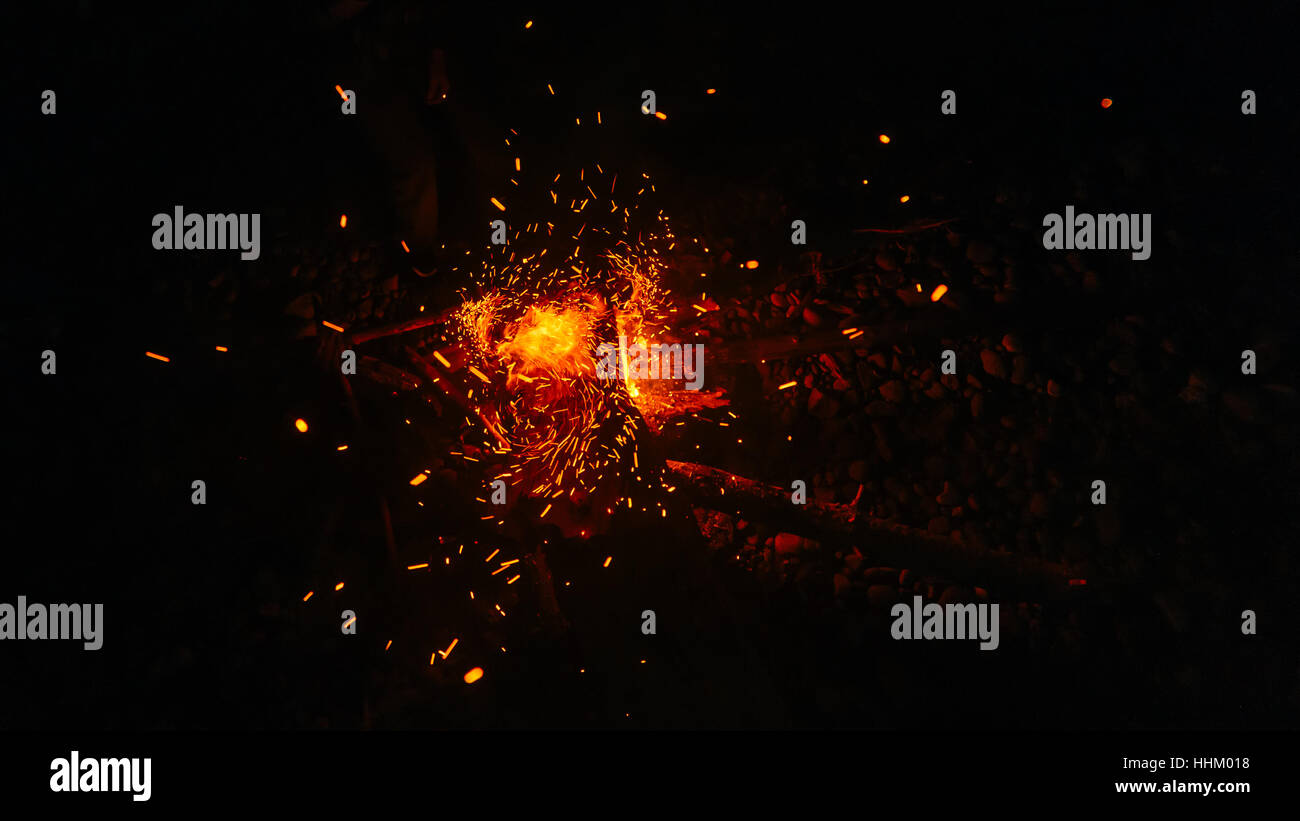 Magic fire on the river bank . Sparks, flames and other wonderful ...