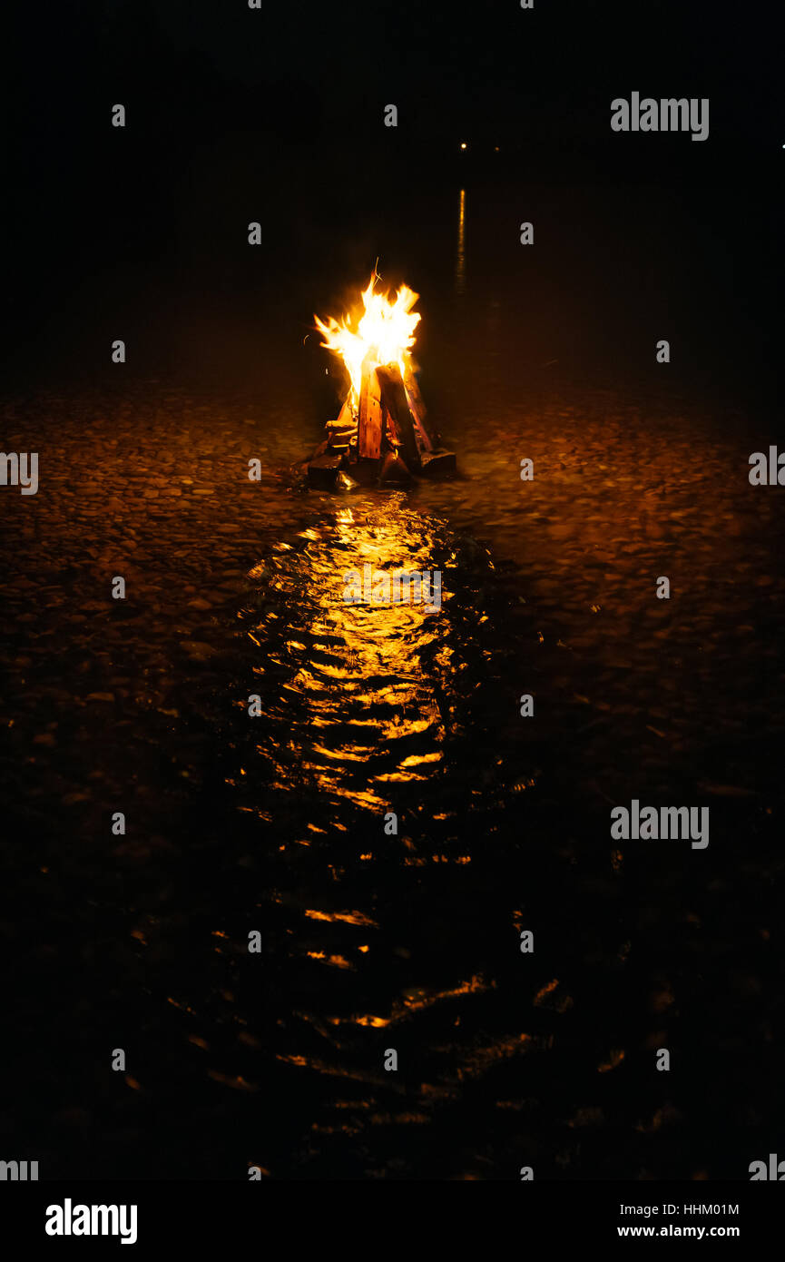 magic fire in the mountain river on the rocks at night Stock Photo - Alamy