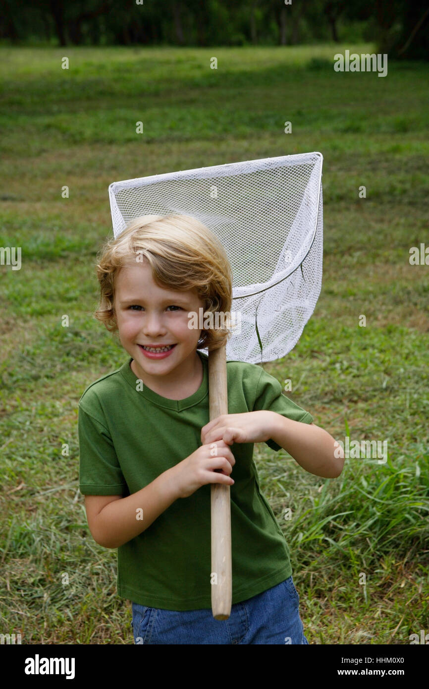 Little boy holding butterfly net, outside Stock Photo - Alamy