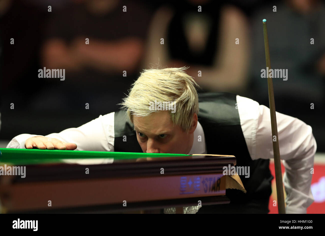 Neil Robertson has a closer look at the line of a shot during his match ...