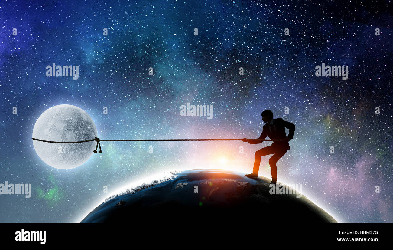 Silhouette of man against starry sky catching moon. Elements of this ...