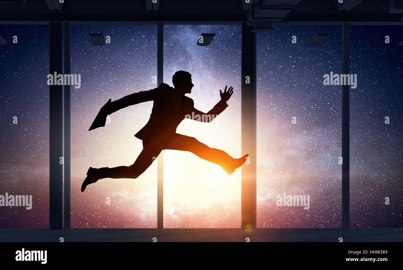 Silhouette businessman jumping over night hi-res stock photography and ...