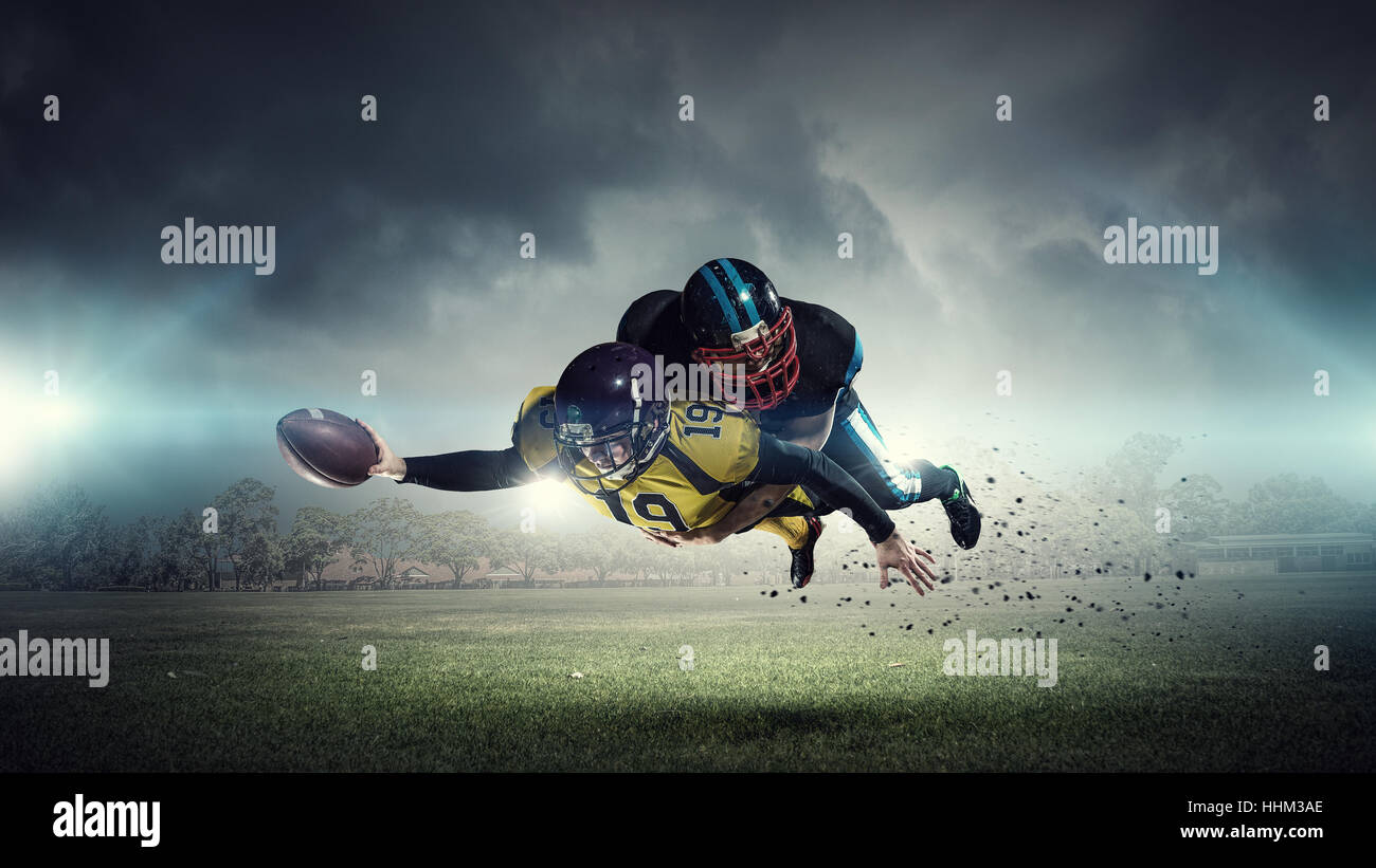 Two american football players fighting for ball . Mixed media Stock ...