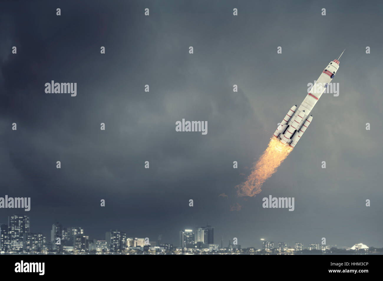 Rocket flying with fire high above city Stock Photo - Alamy