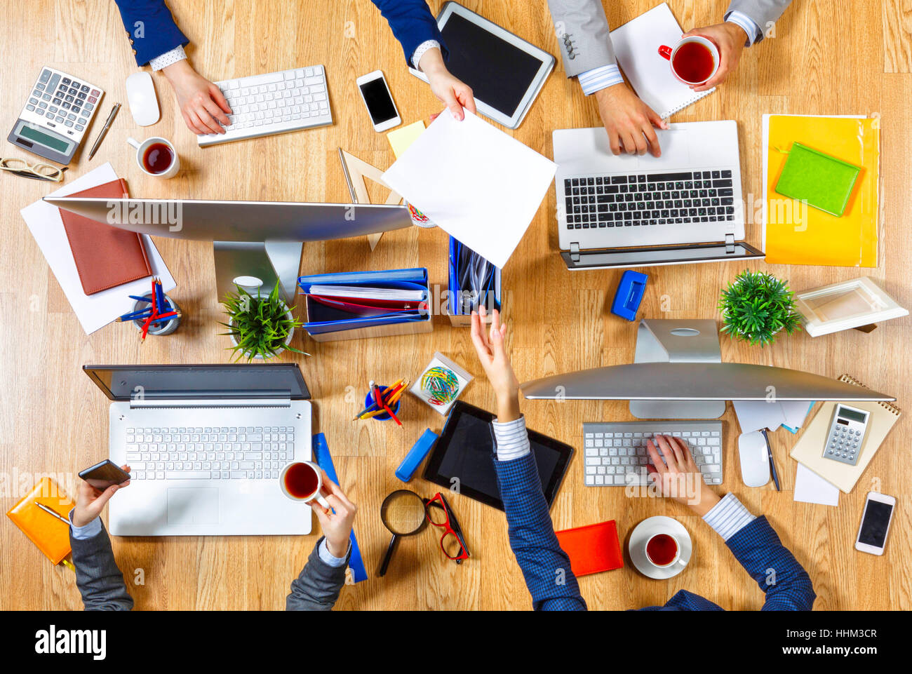 Top view of office table with four colleagues working together Stock ...