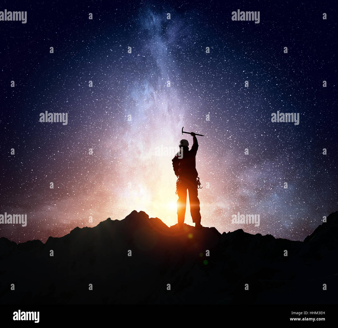 Young brave man alpinist standing on mountain top at night Stock Photo ...