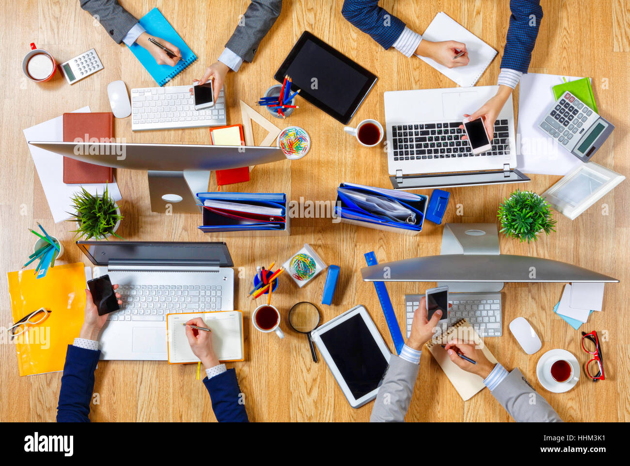 Top view of office table with four colleagues working together Stock ...