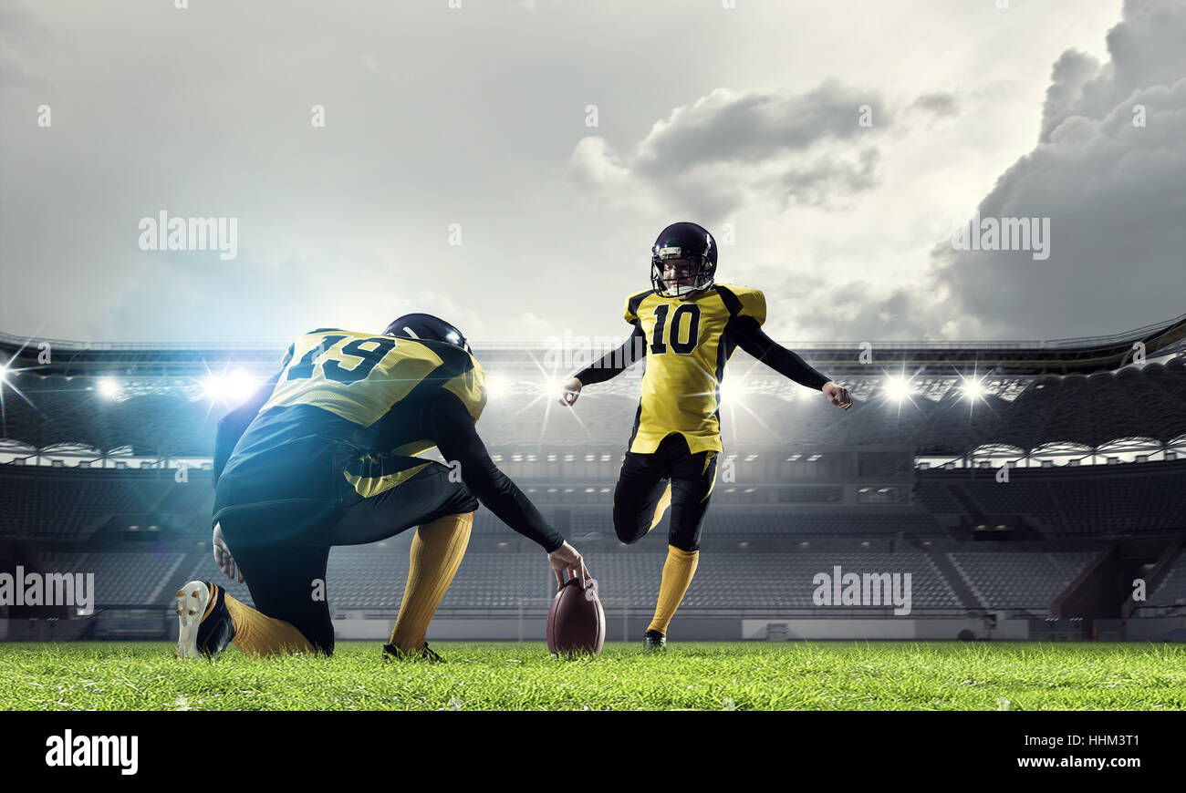 Two american football players fighting for ball. Mixed media Stock ...