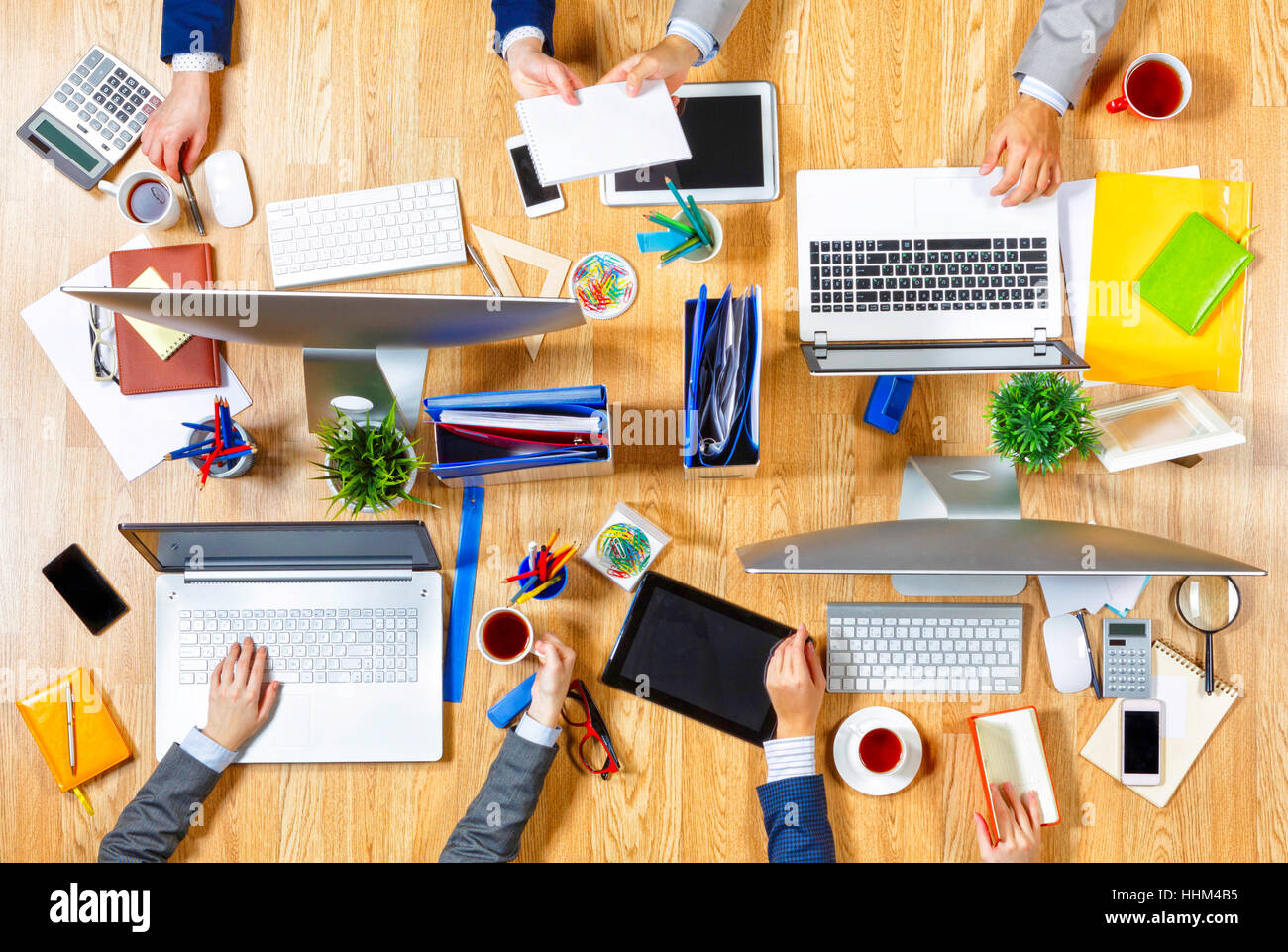 Top view of office table with four colleagues working together Stock ...