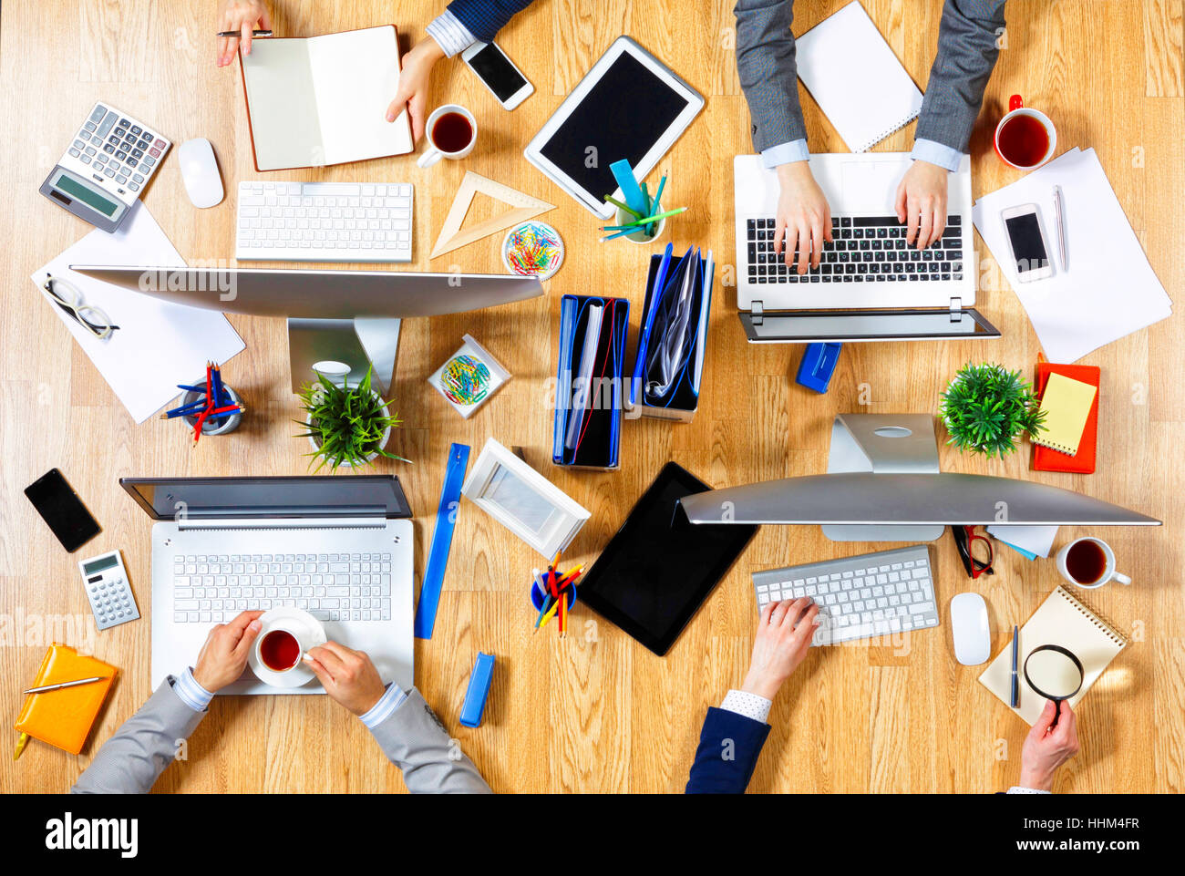 Top view of office table with four colleagues working together Stock ...