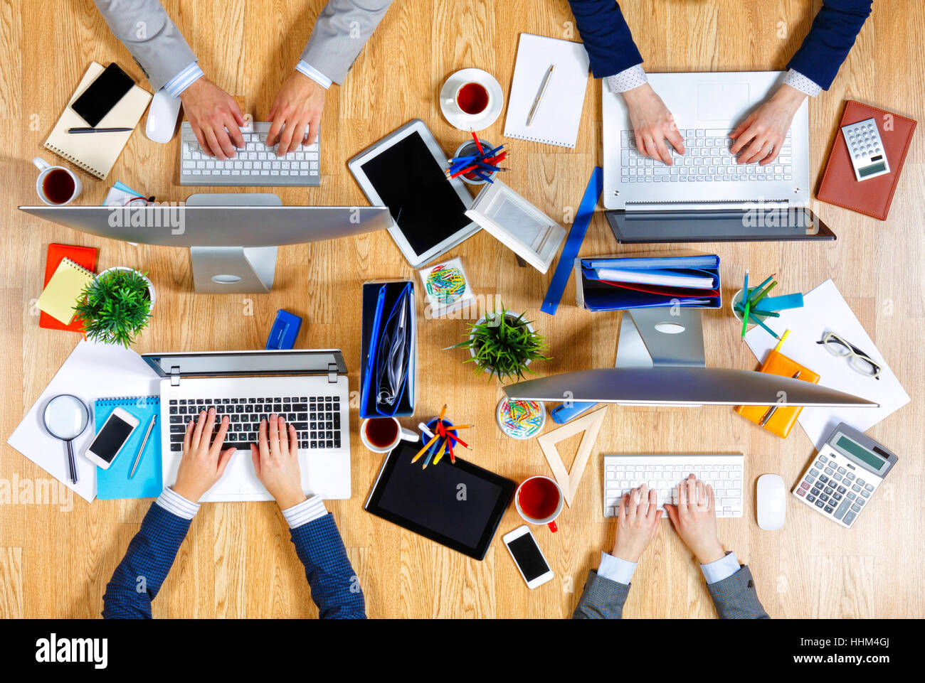 Top view of office table with four colleagues working together Stock ...