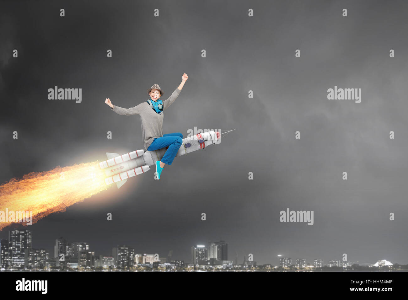 Young cheerful woman traveller riding rocket high in sky Stock Photo ...