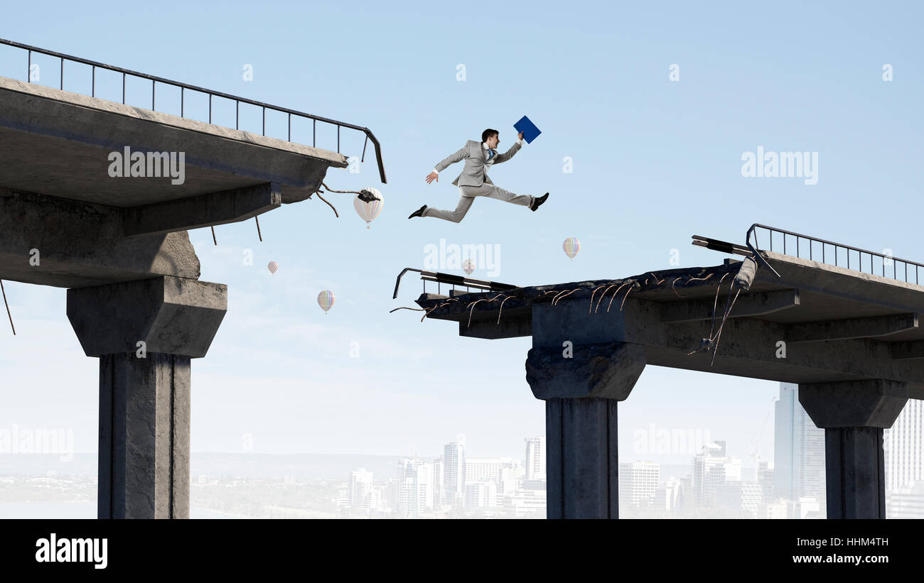 Businessman jumping over a gap in bridge as symbol of problem ...