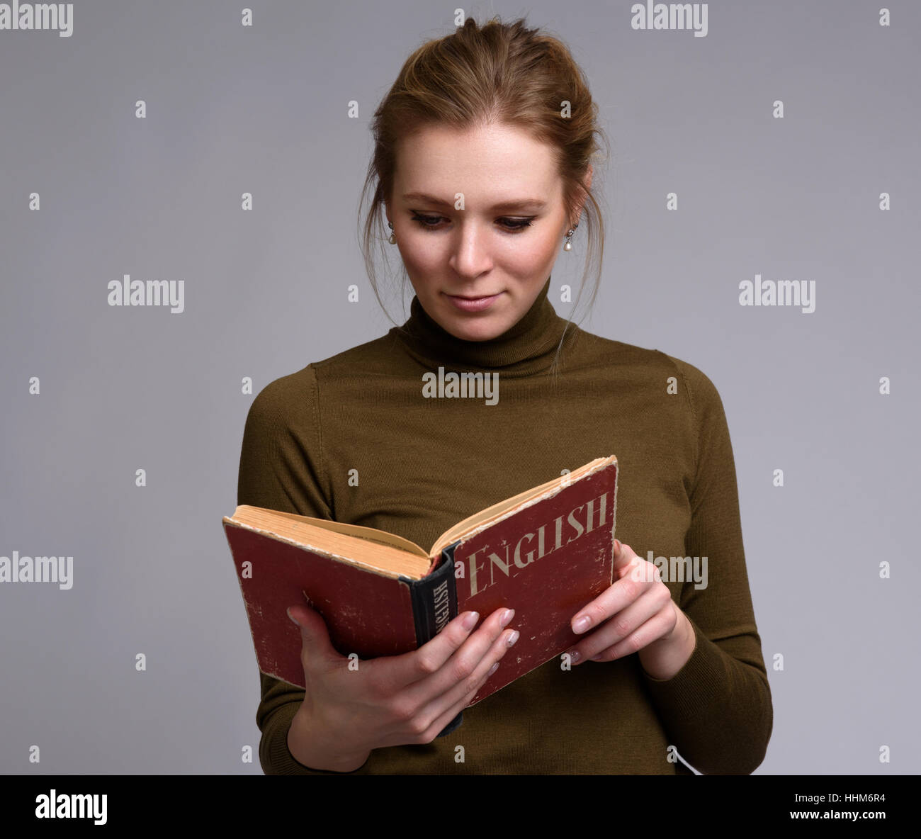 young pretty girl reading a book. Study english language concept Stock ...