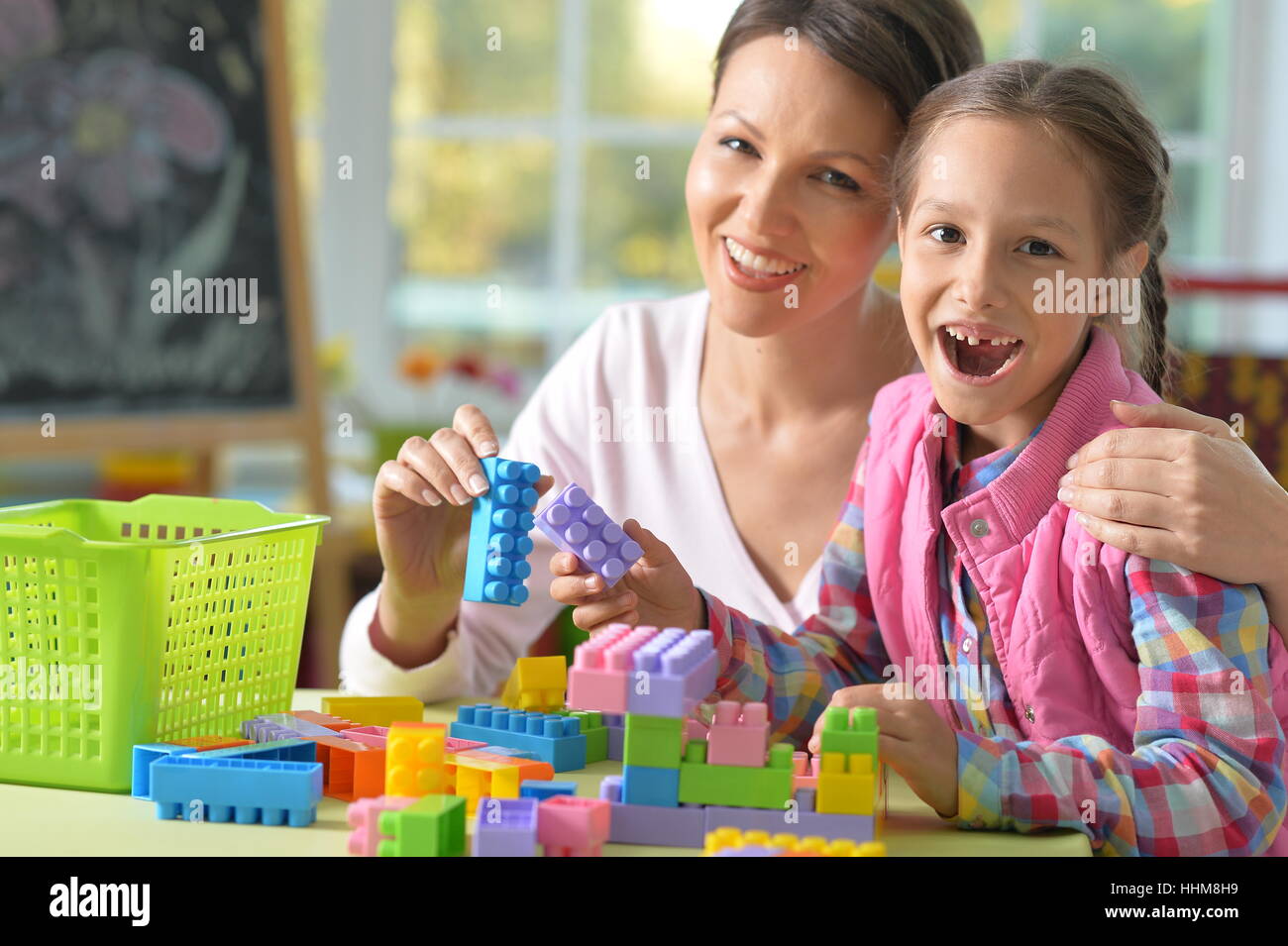 Mother and daughter play lego Stock Photo - Alamy