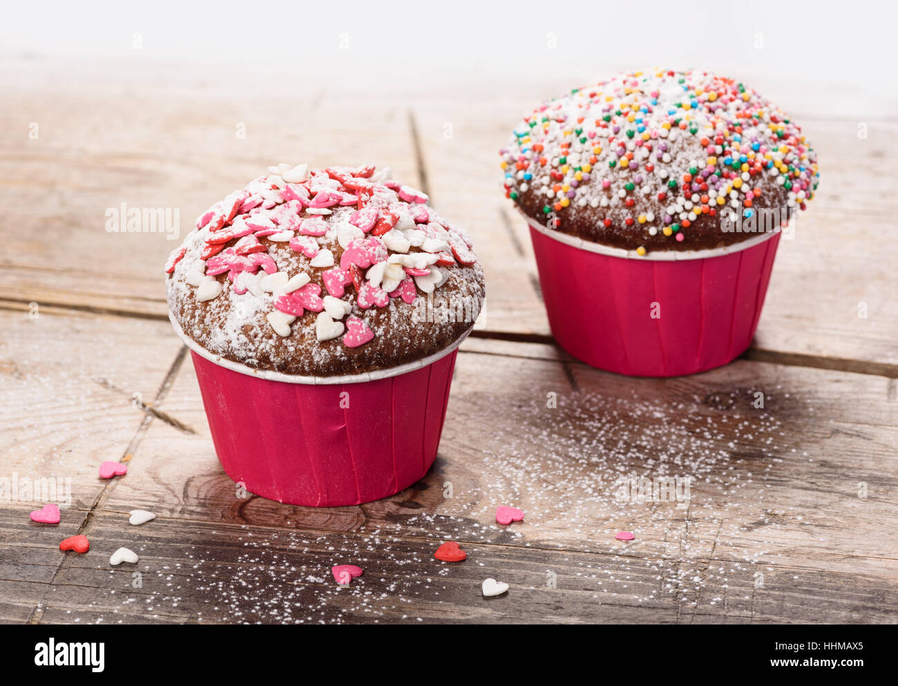 Tasty two muffins on a wooden table Stock Photo - Alamy